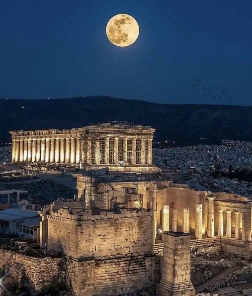 Full moon seen rising over the Acropolis and Temple of Poseidon in ...