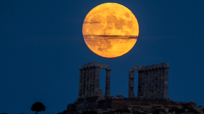 Full moon seen rising over the Acropolis and Temple of Poseidon in ...
