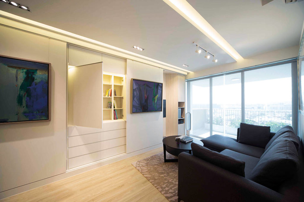 See how sliding walls in this apartment transform the living room into ...